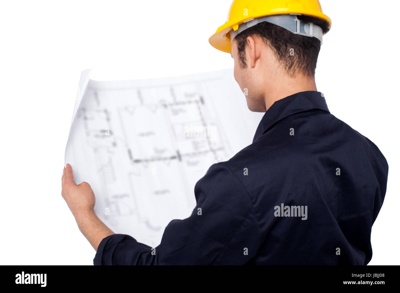 Young male engineer with construction plan Stock Photo - Alamy