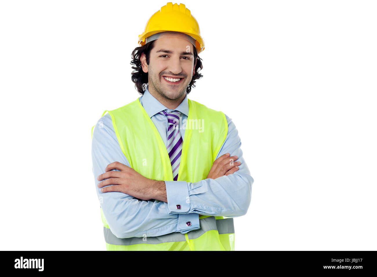 Smiling construction engineer posing with arms crossed Stock Photo - Alamy