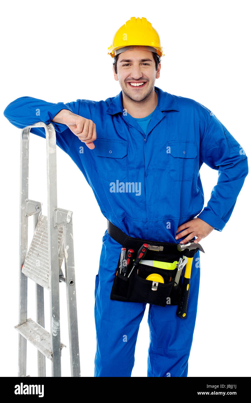 Smiling handyman posing near his step ladder Stock Photo - Alamy