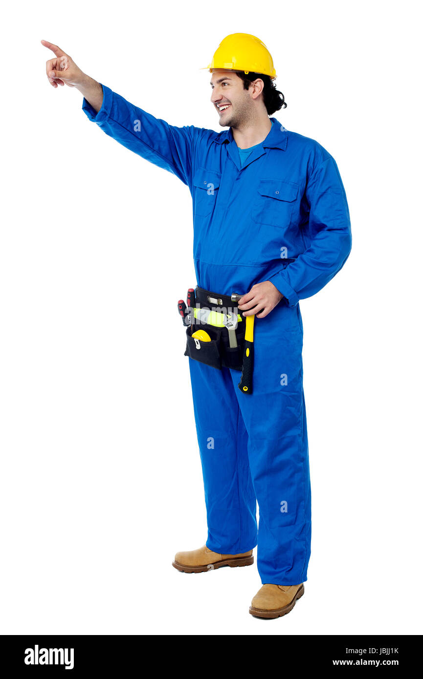 Smiling construction worker pointing up Stock Photo - Alamy