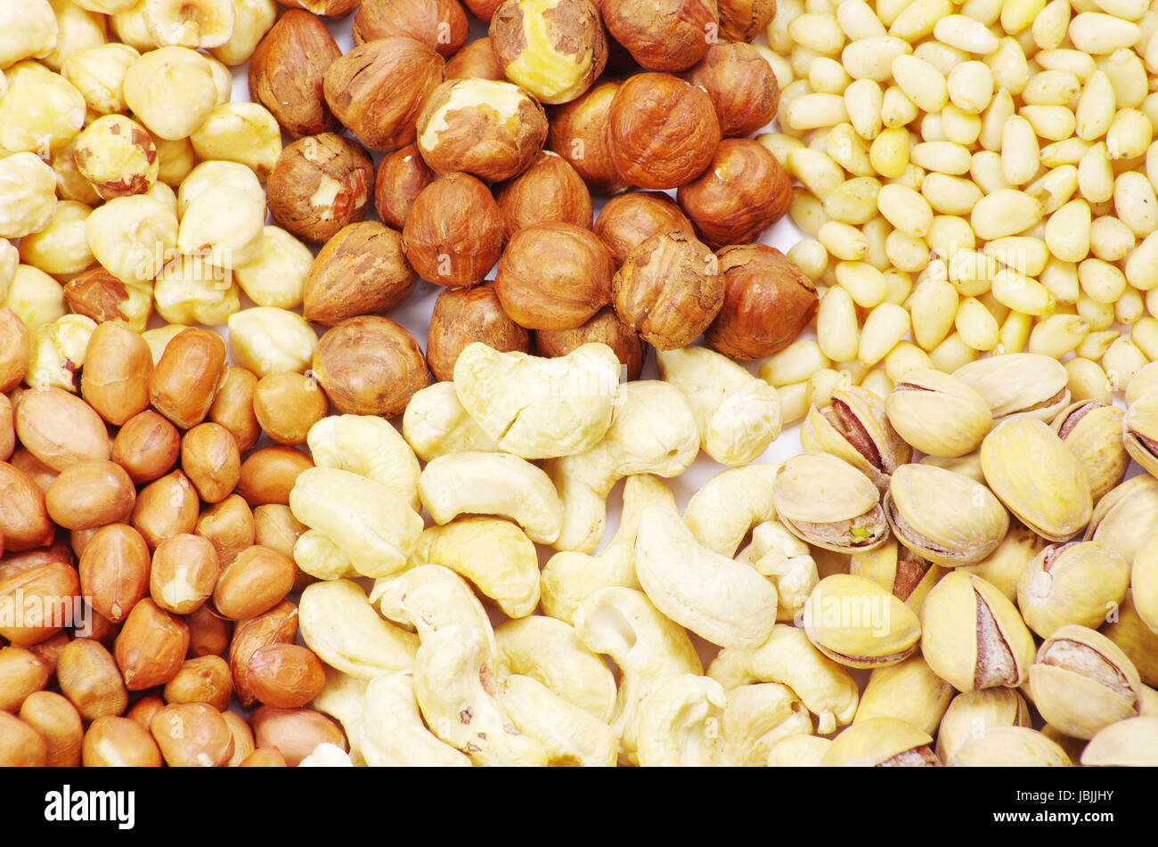 mixed nuts on a background Stock Photo - Alamy