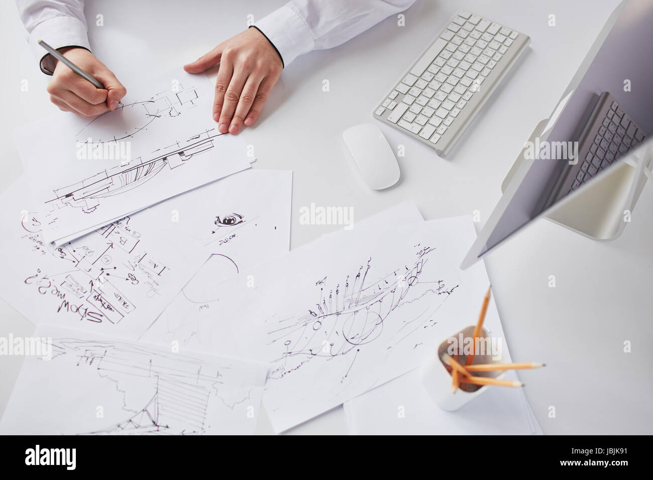 Image of sketches at workplace being drawn by businessman Stock Photo ...