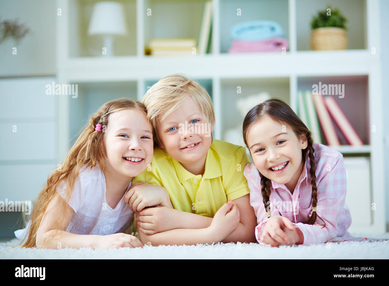 Three little friends looking at camera with smiles Stock Photo - Alamy