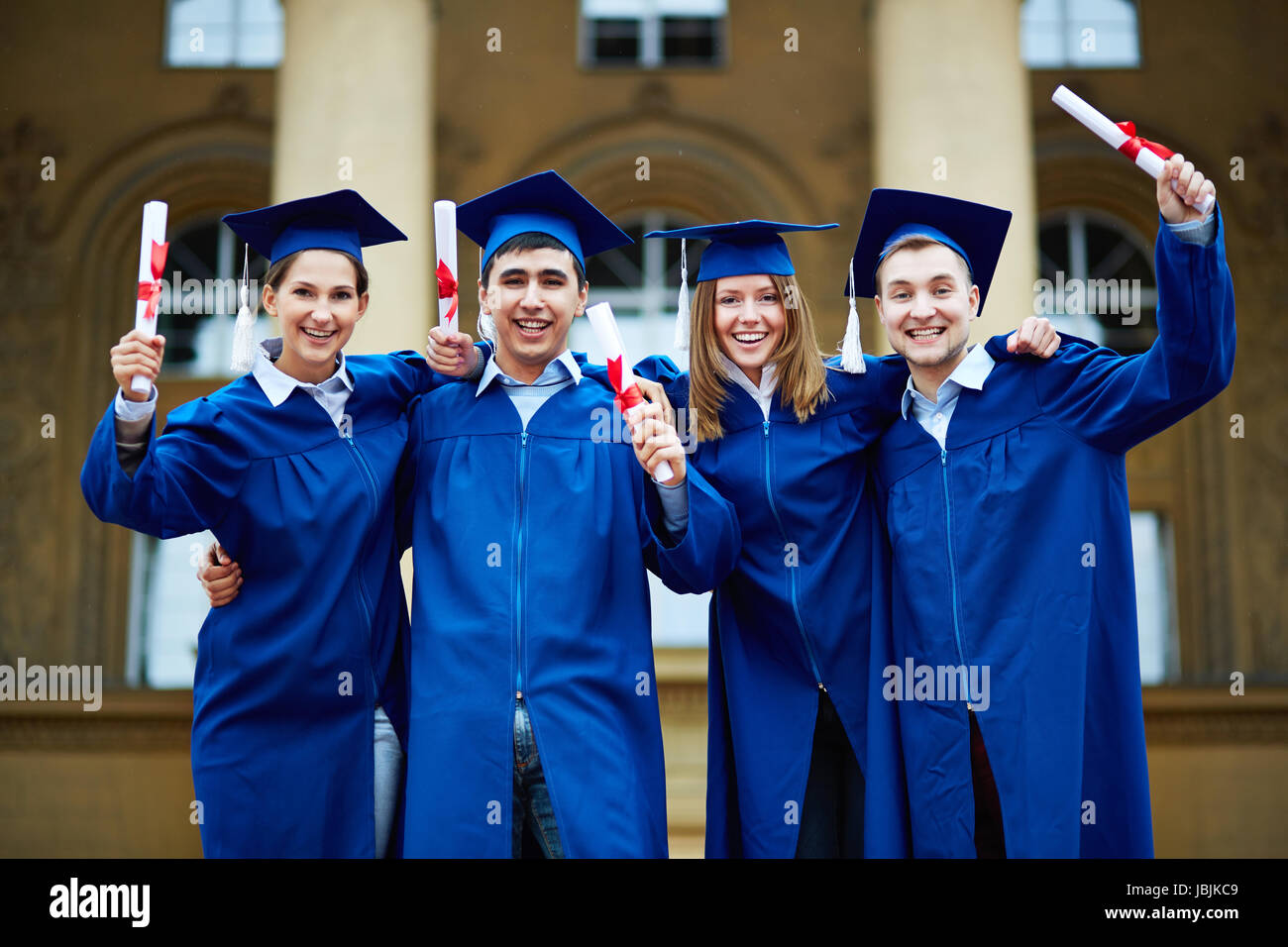 Group of smart students in graduation gowns holding diplomas Stock ...