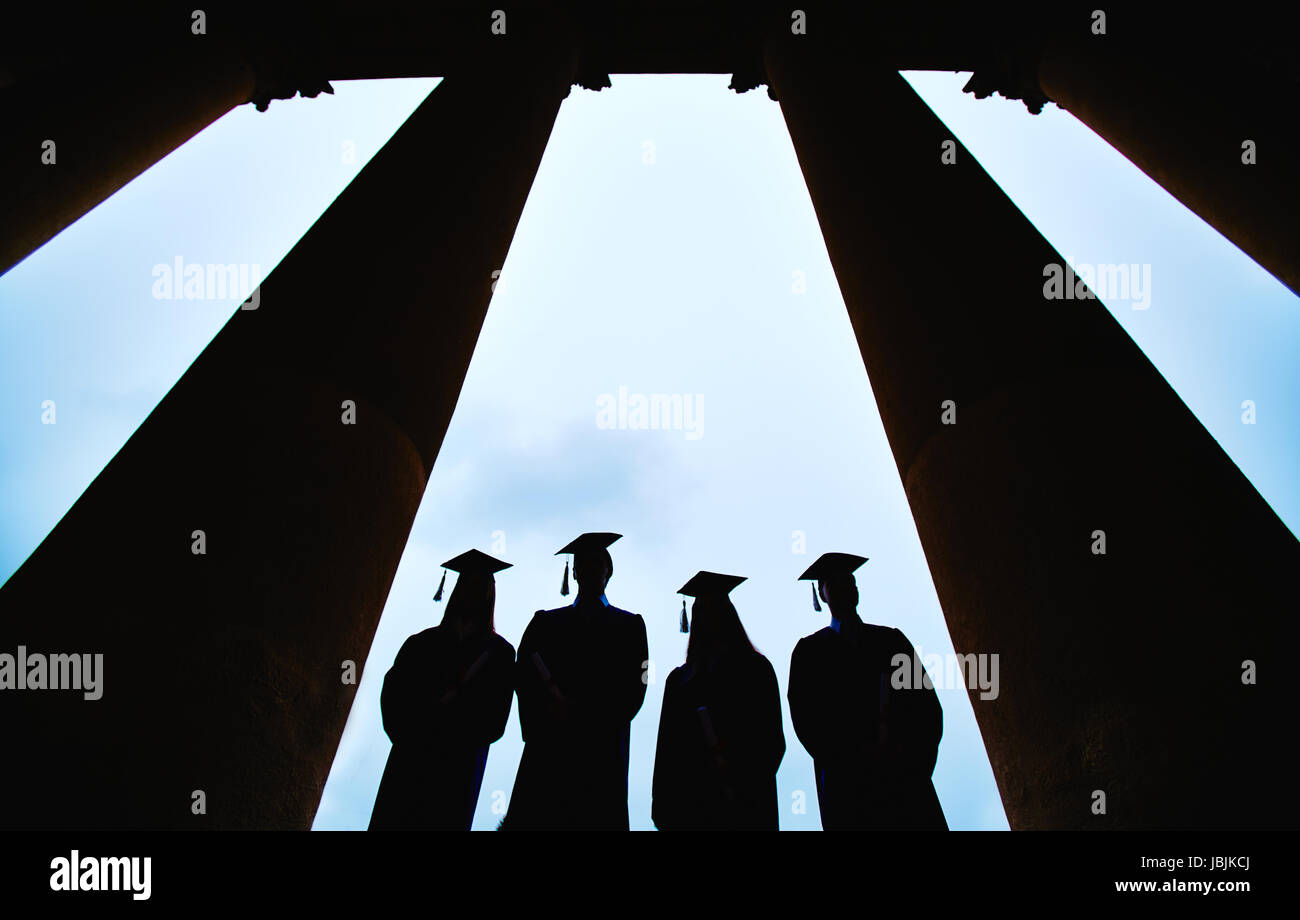 Outlines of four graduates between columns of university building Stock ...