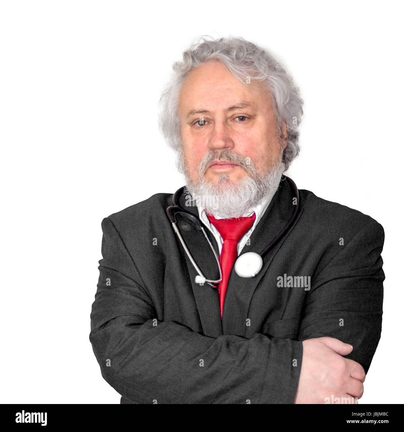 A gray haired and bearded doctor looking serious neutral Stock Photo ...