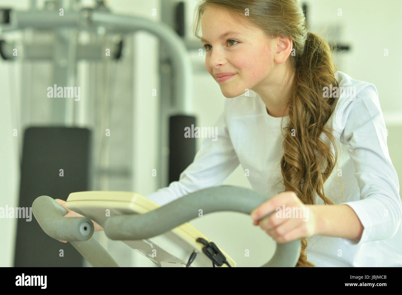 Little girl doing exercises in a gym Stock Photo - Alamy