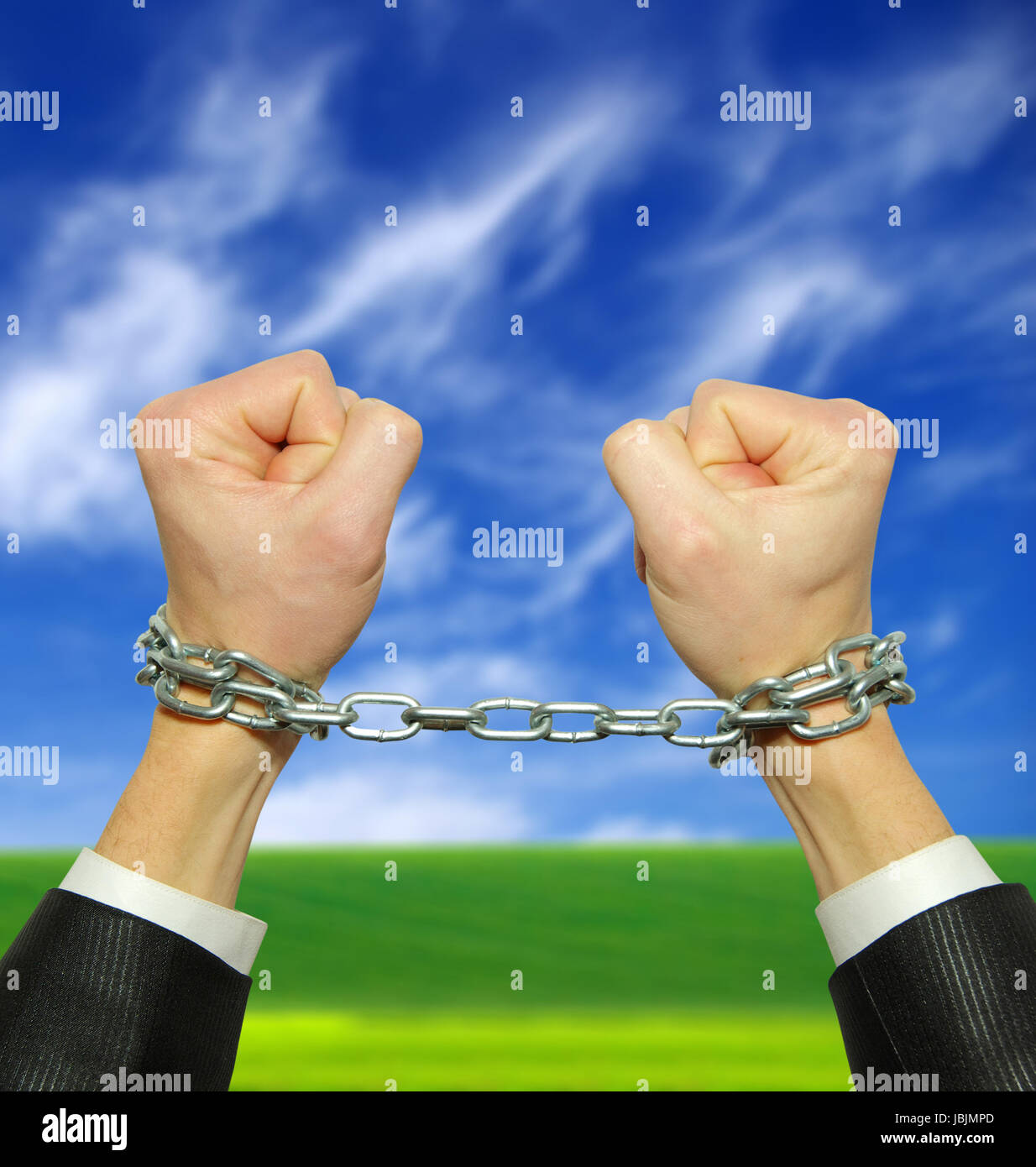 Hands in chains on a background sky Stock Photo - Alamy