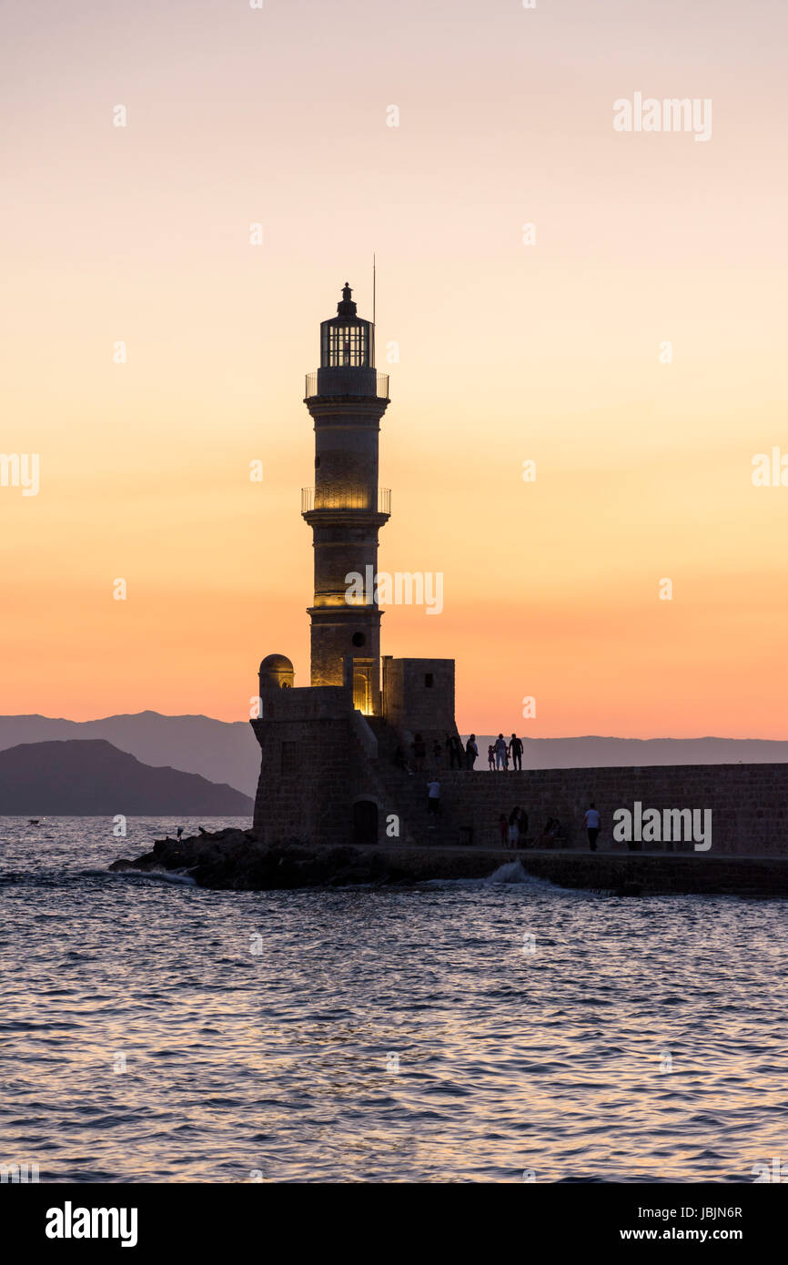 Sunset view over the Chania lighthouse at the entrance to the Venetian ...