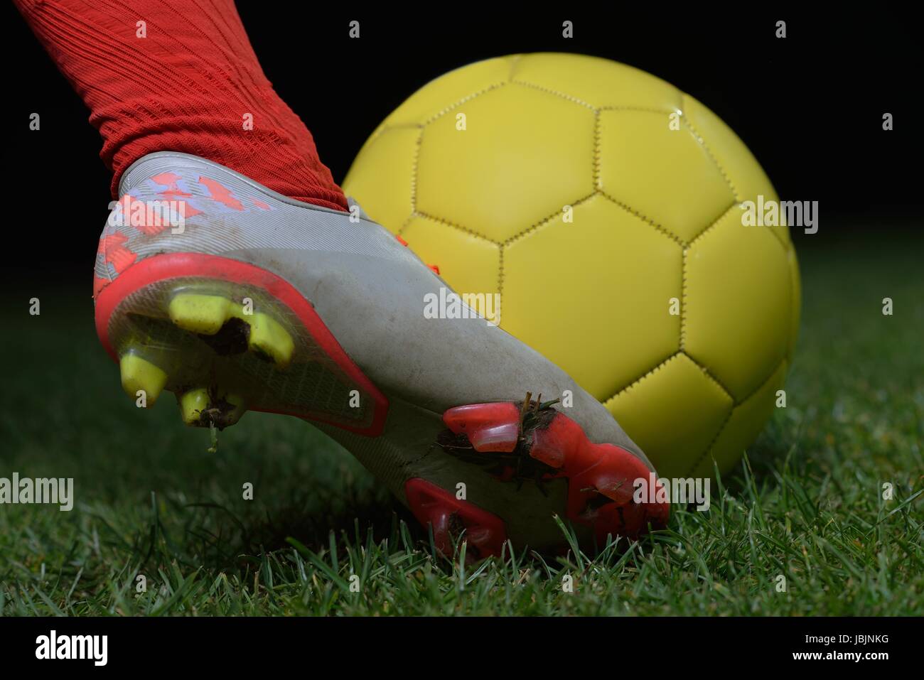 soccer player doing kick with ball on football stadium field isolated ...