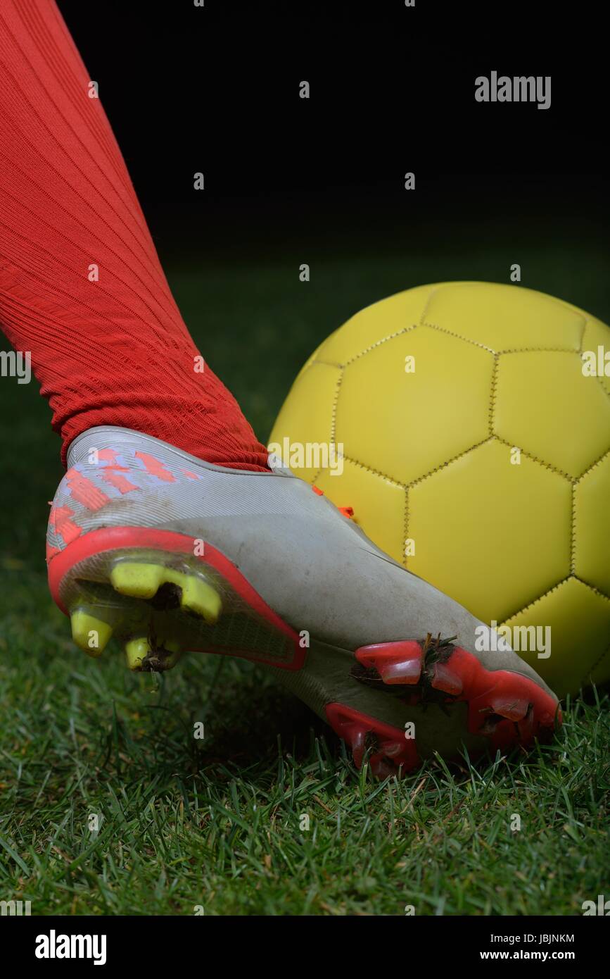 soccer player doing kick with ball on football stadium field isolated ...