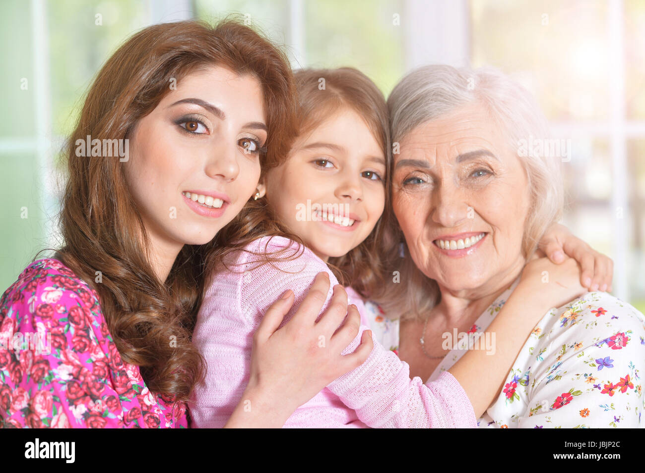 Happy family portrait of three female generations Stock Photo - Alamy