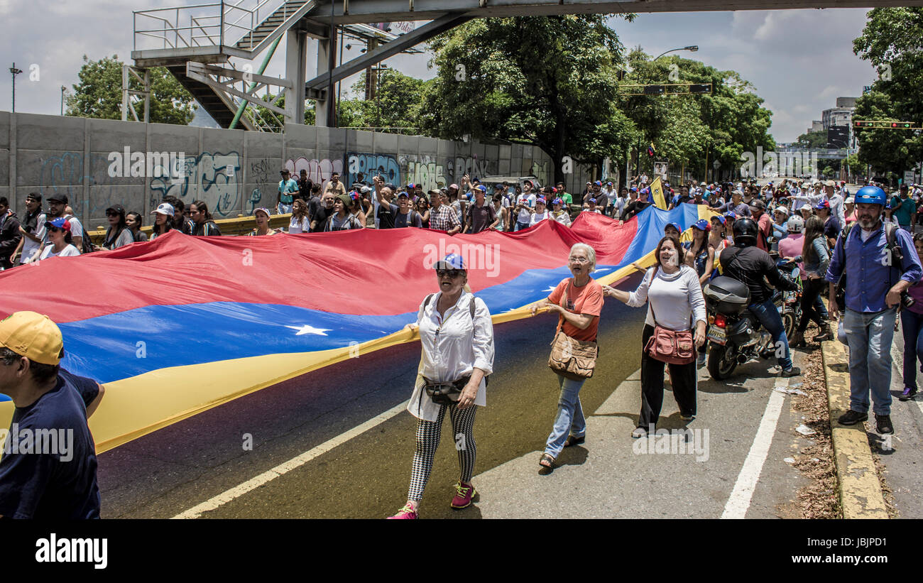 An anti-government protester stands in front of burning barricade on a ...