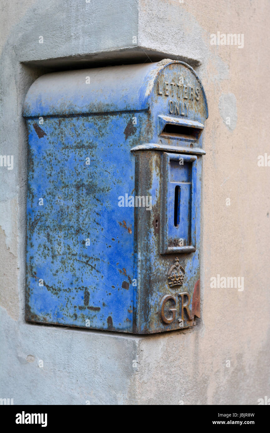 Blue old mail box build into wall Stock Photo - Alamy