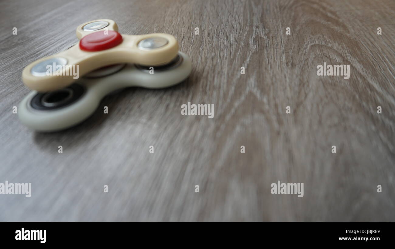 two hand spinner lying on grey laminate Stock Photo - Alamy