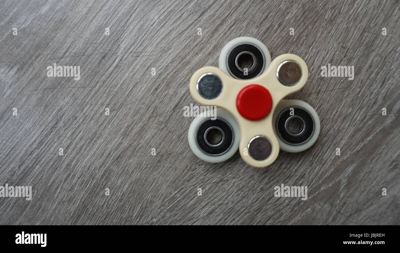 two hand spinner lying on grey laminate Stock Photo - Alamy