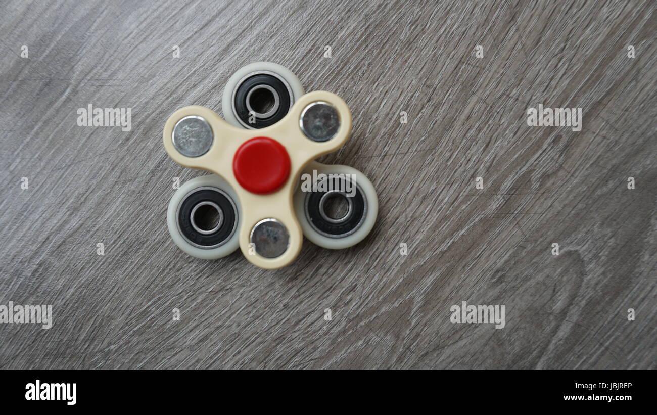 two hand spinner lying on grey laminate Stock Photo - Alamy