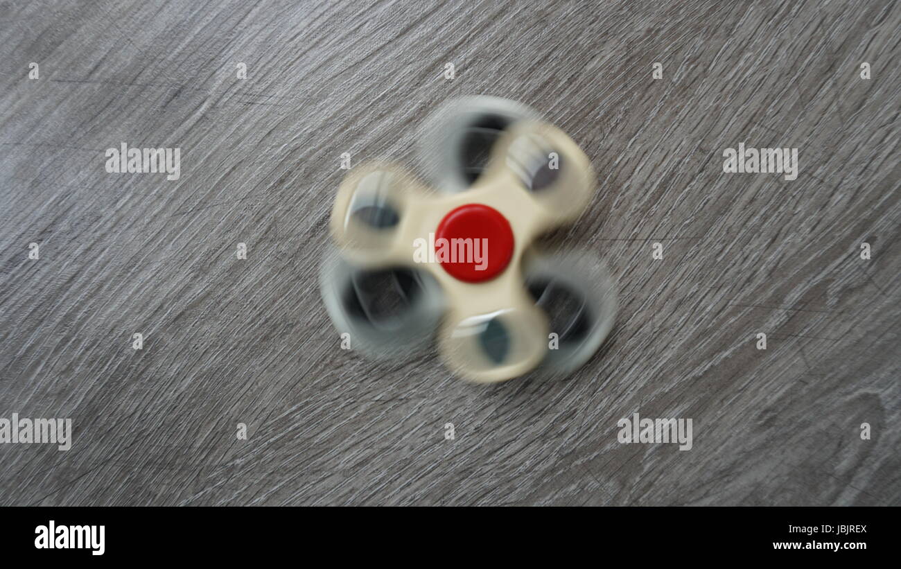 two hand spinner lying on grey laminate Stock Photo - Alamy