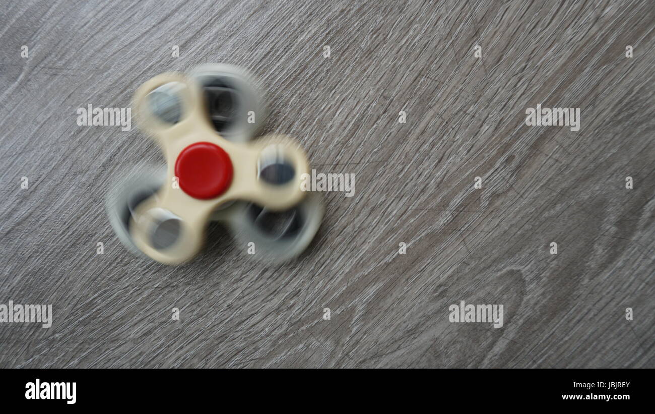 two hand spinner lying on grey laminate Stock Photo - Alamy