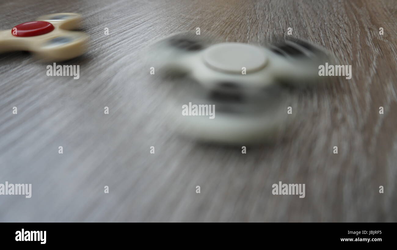 two hand spinner lying on grey laminate Stock Photo - Alamy