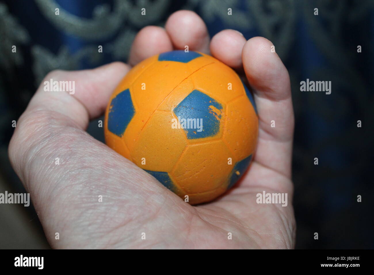 small soccer ball in hand young man Stock Photo - Alamy