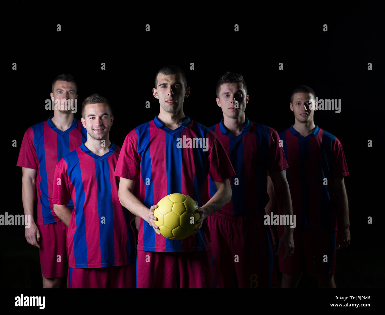 soccer players team group isolated on black background Stock Photo - Alamy
