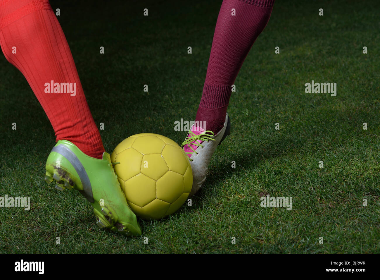 soccer player doing kick with ball on football stadium field isolated ...