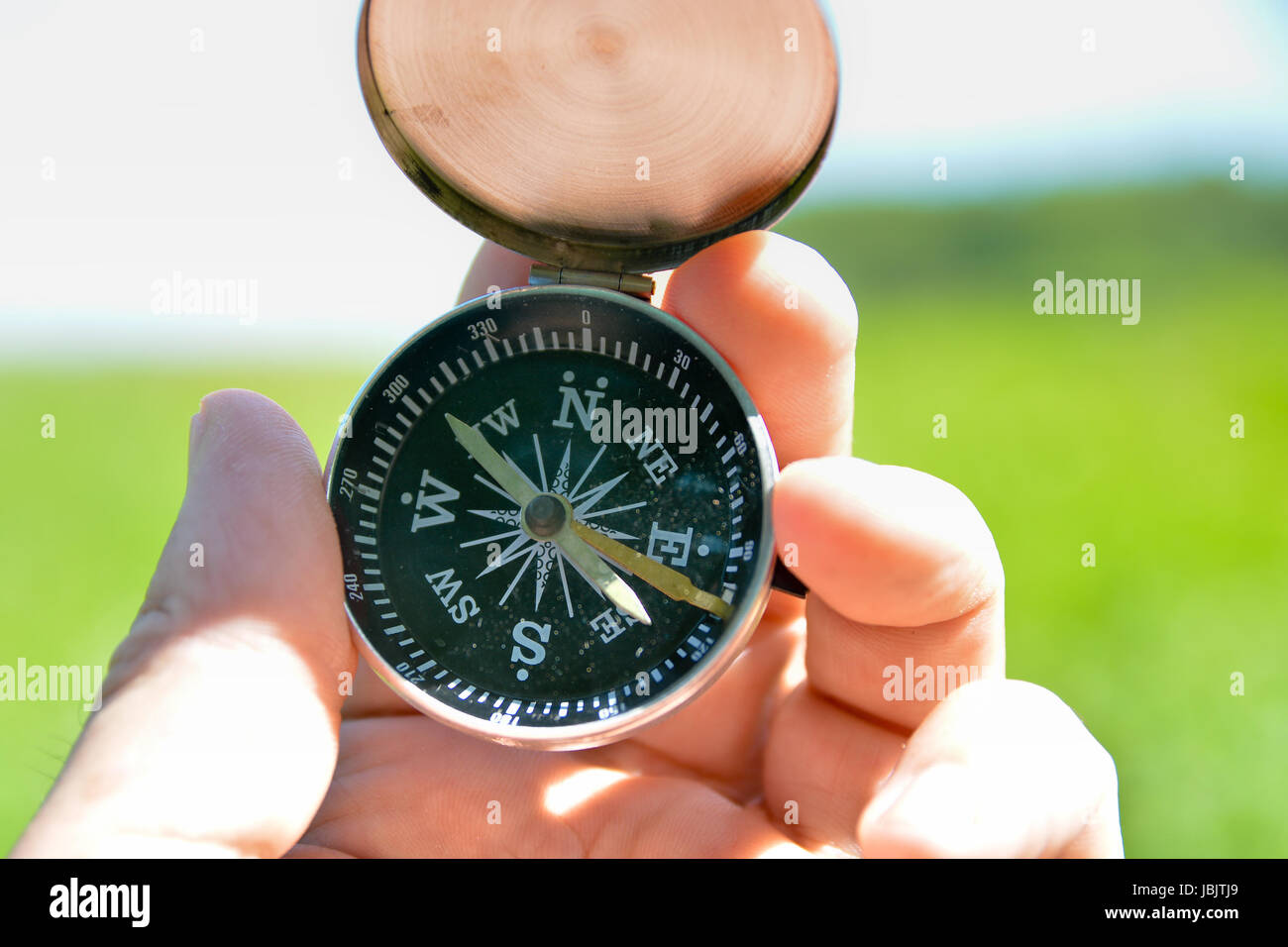 Compass in hand. A navigation tool for off-road orientation Stock Photo ...