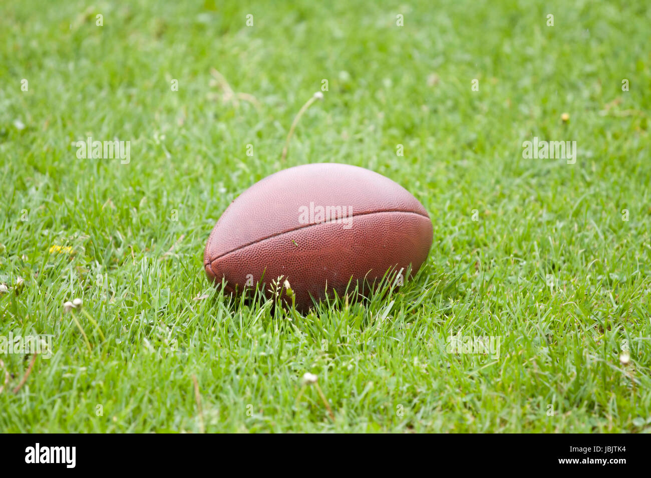 American Football on the ground Stock Photo - Alamy