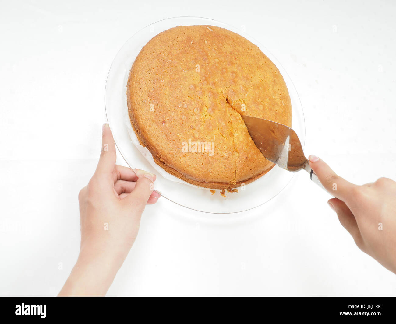 Female person cutting a slice from fresh baked cake Stock Photo - Alamy