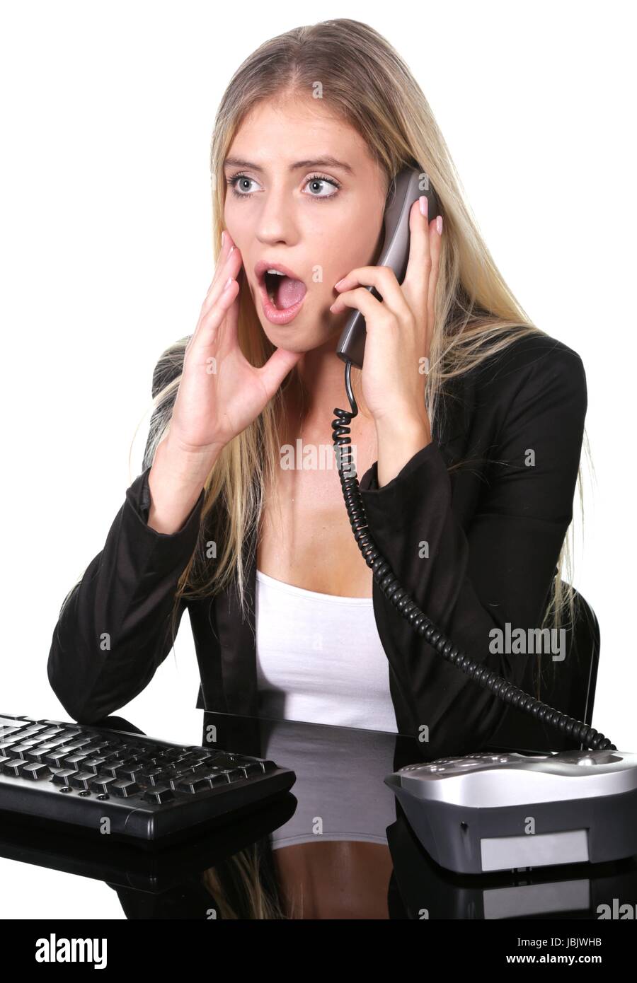 Pretty blond office secretary lady talkiing on telephone with shocked ...