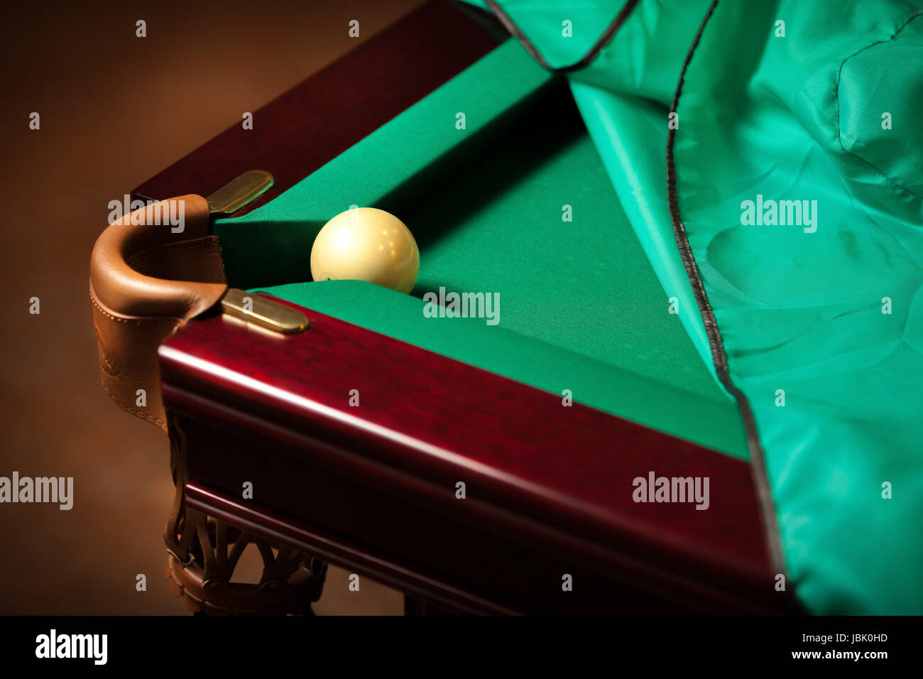 Ball in billiard pocket on partly covered table Stock Photo - Alamy