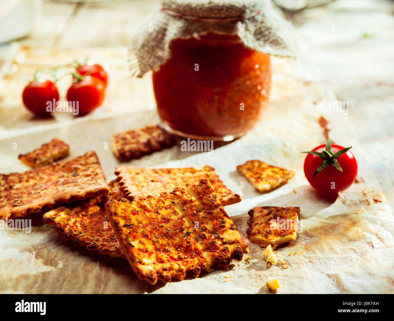 Savoury spicy crisp Italian crackers with preserve and fresh cherry ...