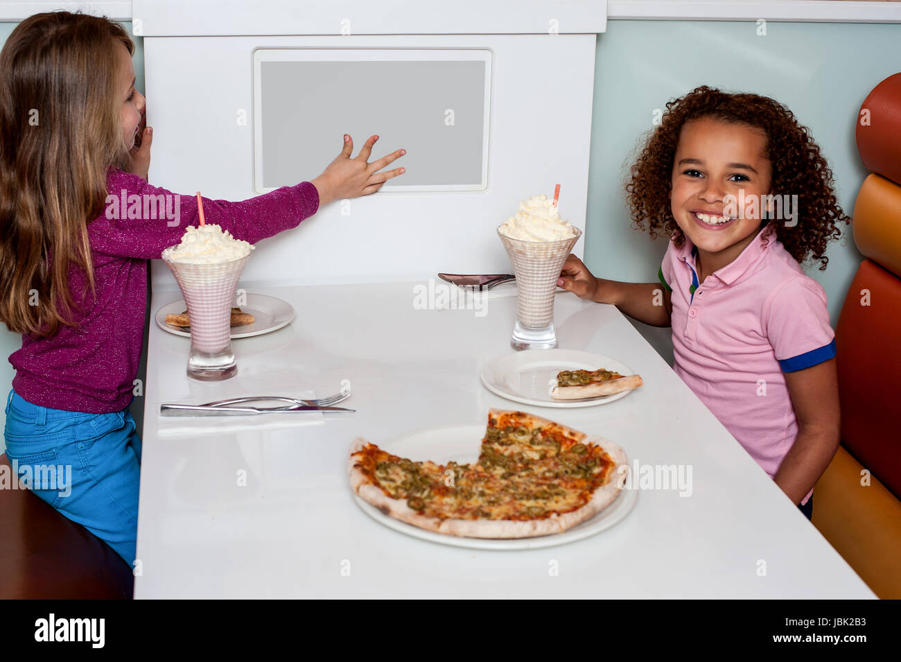 Little girls placing an order through digital menu Stock Photo - Alamy