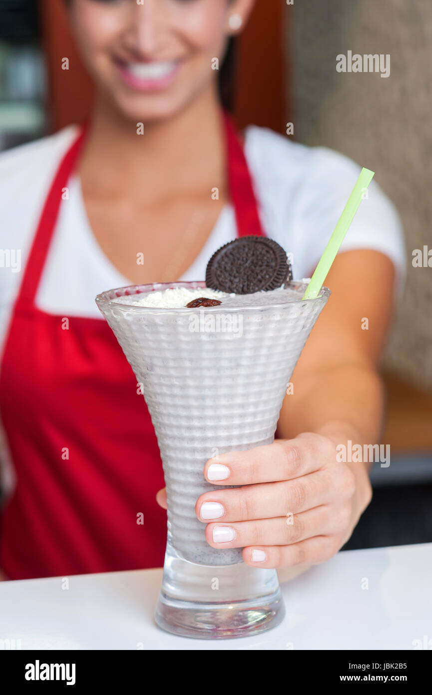 Cropped image of chef serving fresh shake with a cookie Stock Photo - Alamy