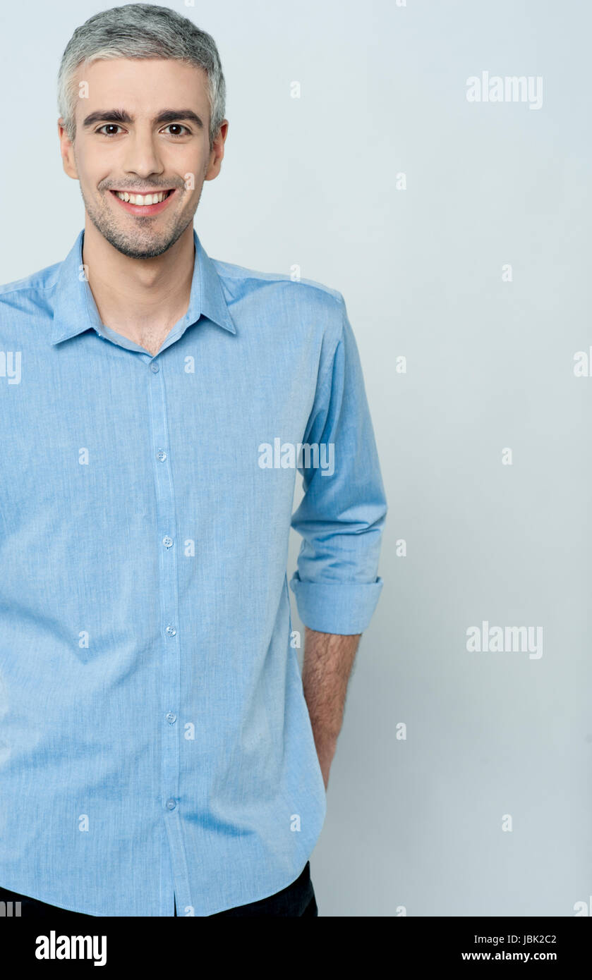 Handsome smiling man posing casually Stock Photo - Alamy