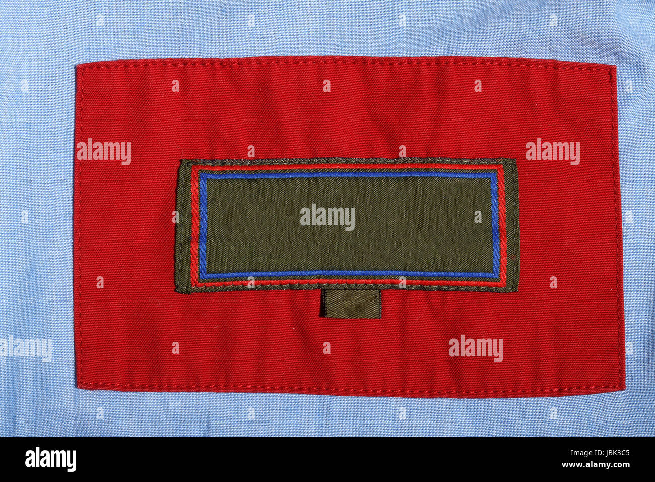 green label on red cotton fabric Stock Photo - Alamy
