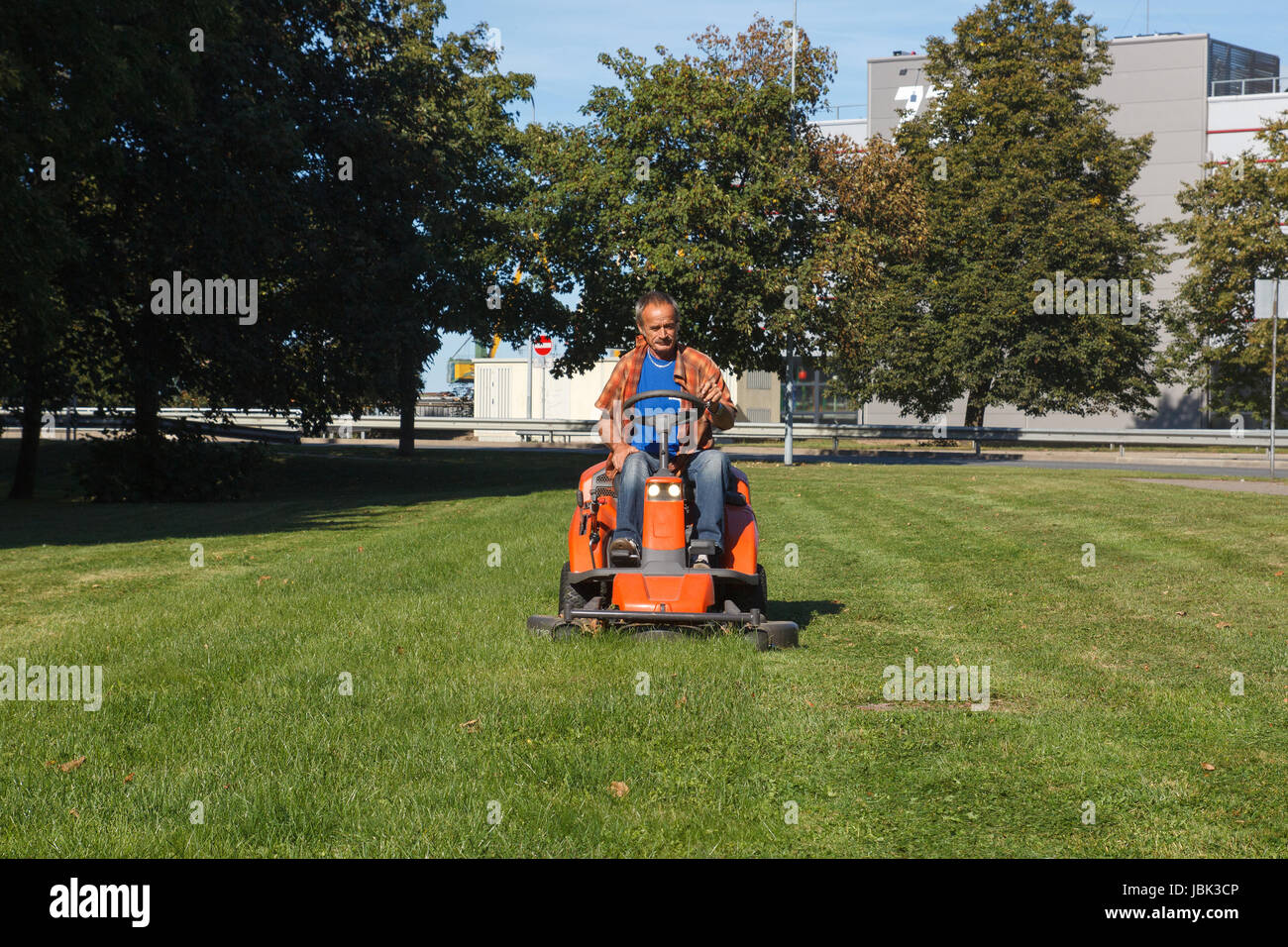 Worker driving lawn mower hi-res stock photography and images - Alamy