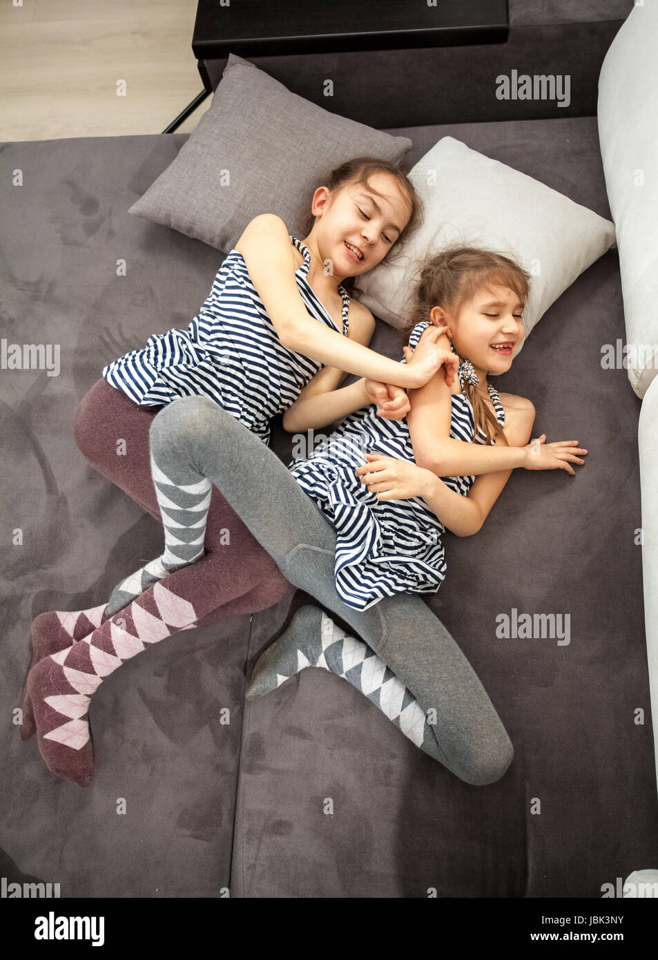 Two young sisters fighting on bed Stock Photo - Alamy