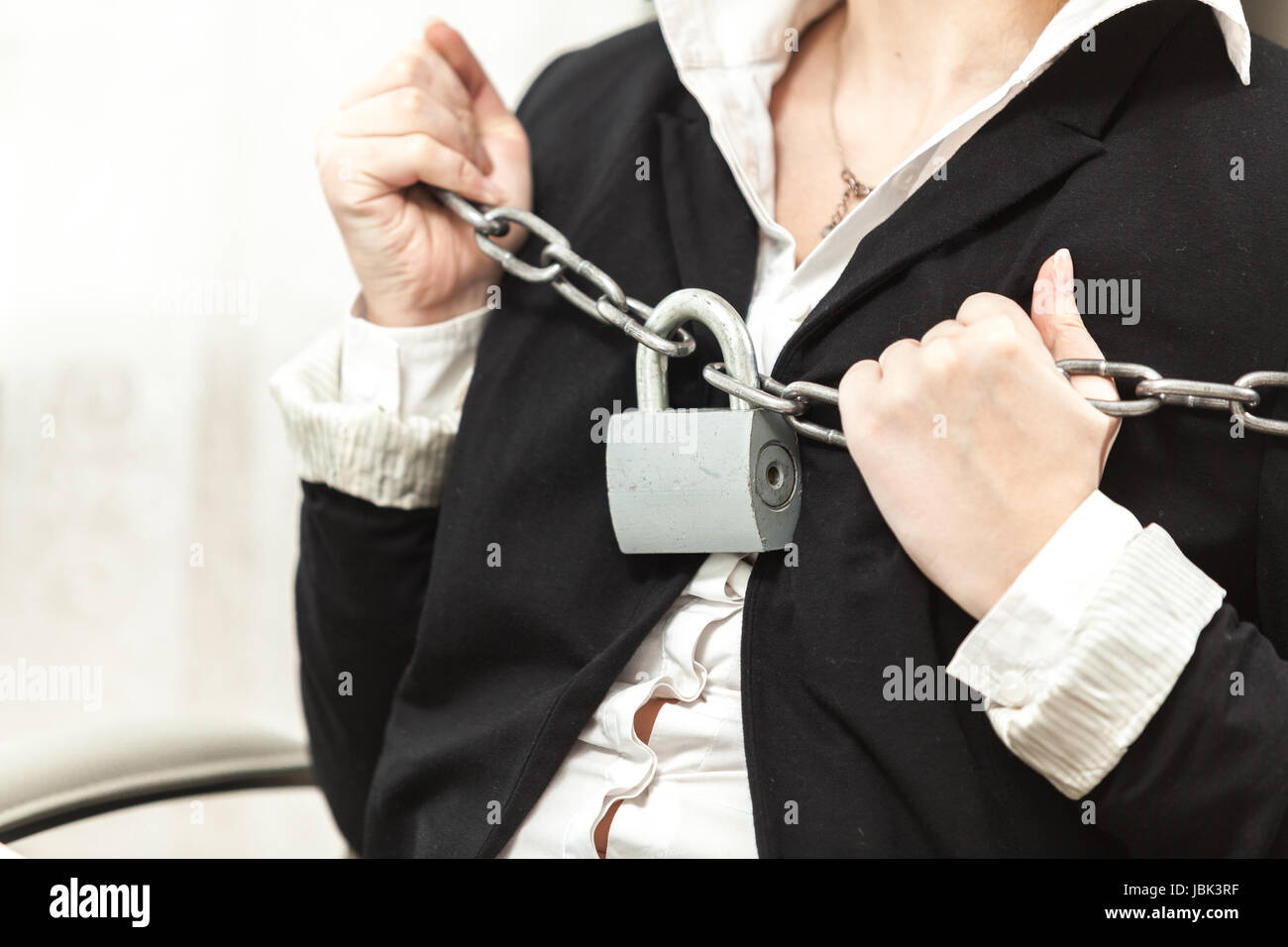 Closeup photo of businesswoman being locked by chain and padlock Stock ...