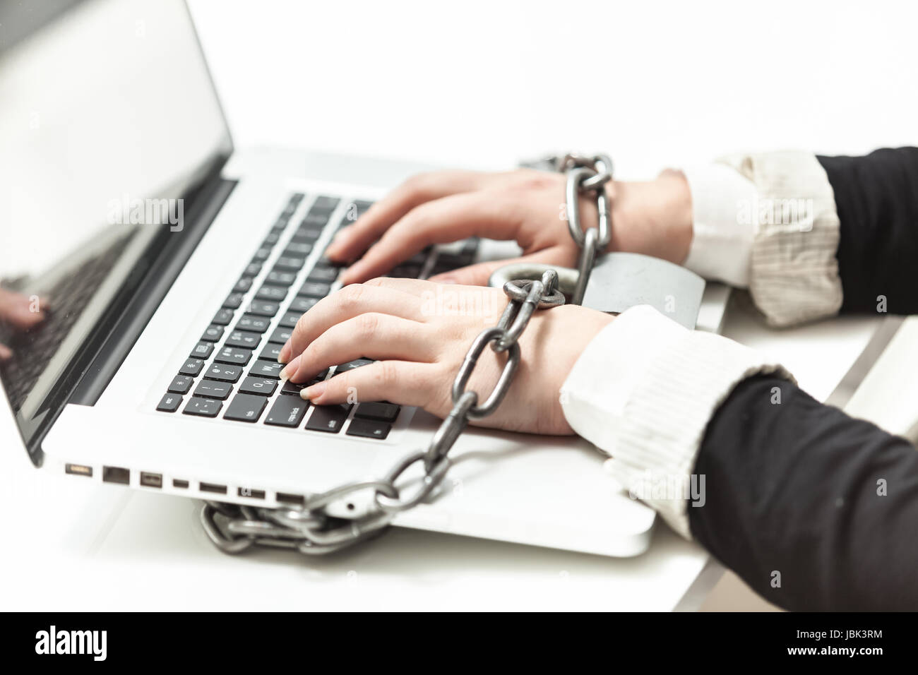Photo of female locked to laptop by chain Stock Photo - Alamy