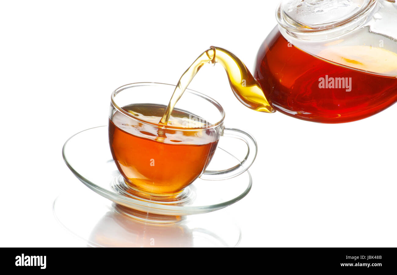 Tea being poured into glass tea cup Stock Photo - Alamy