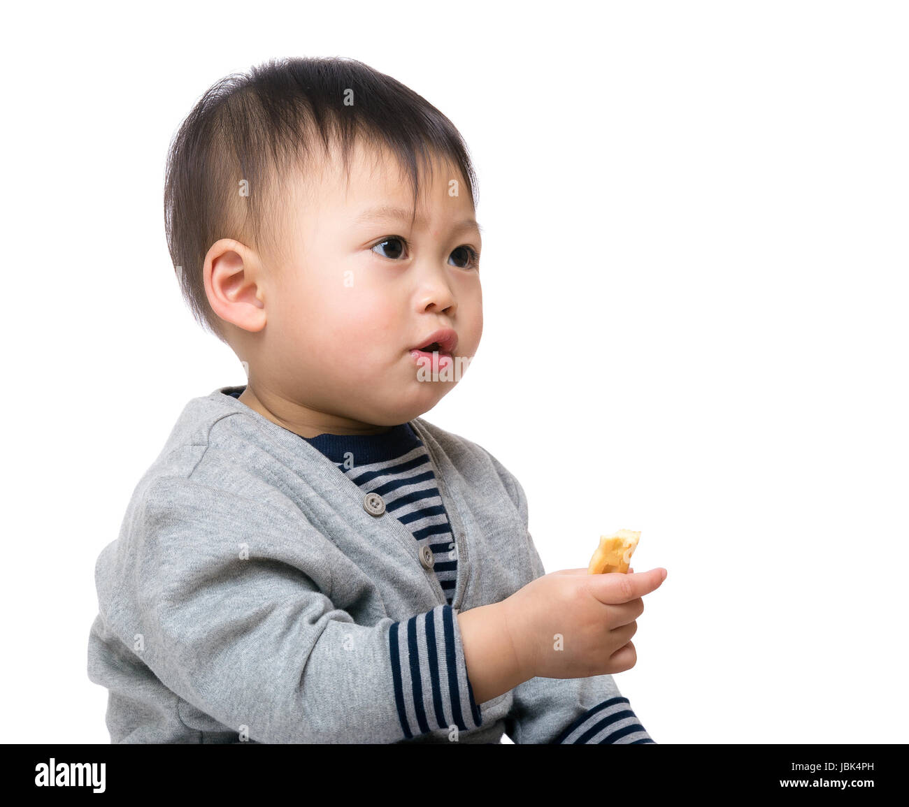 Baby boy eating biscuit Stock Photo - Alamy