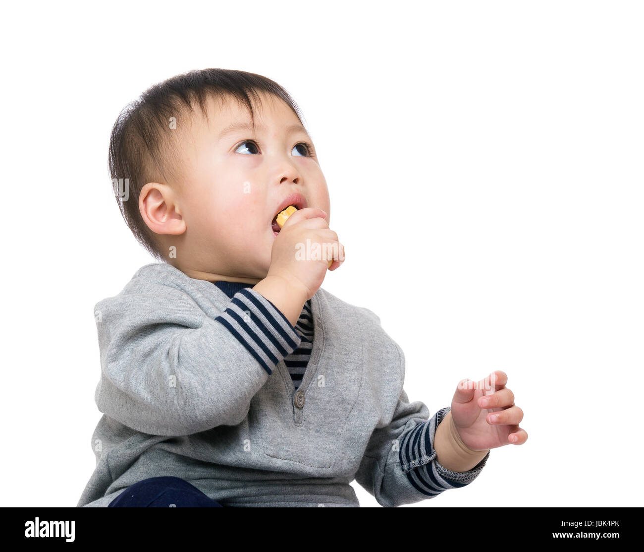 Baby boy eating snack Stock Photo - Alamy