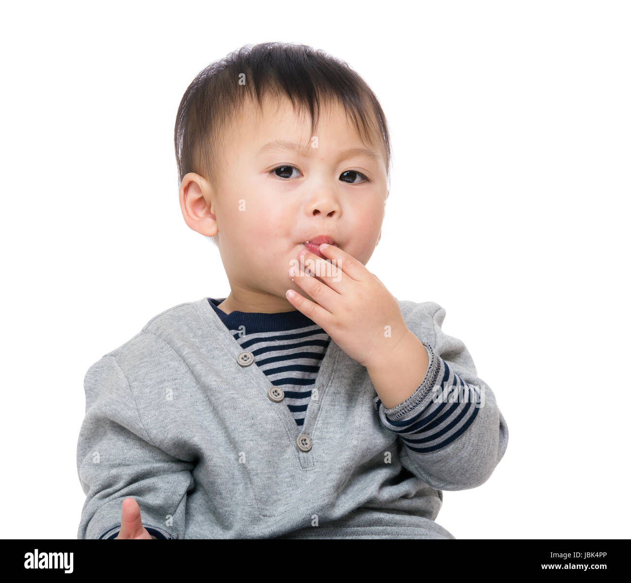 Kid snacking on cracker Stock Photo - Alamy