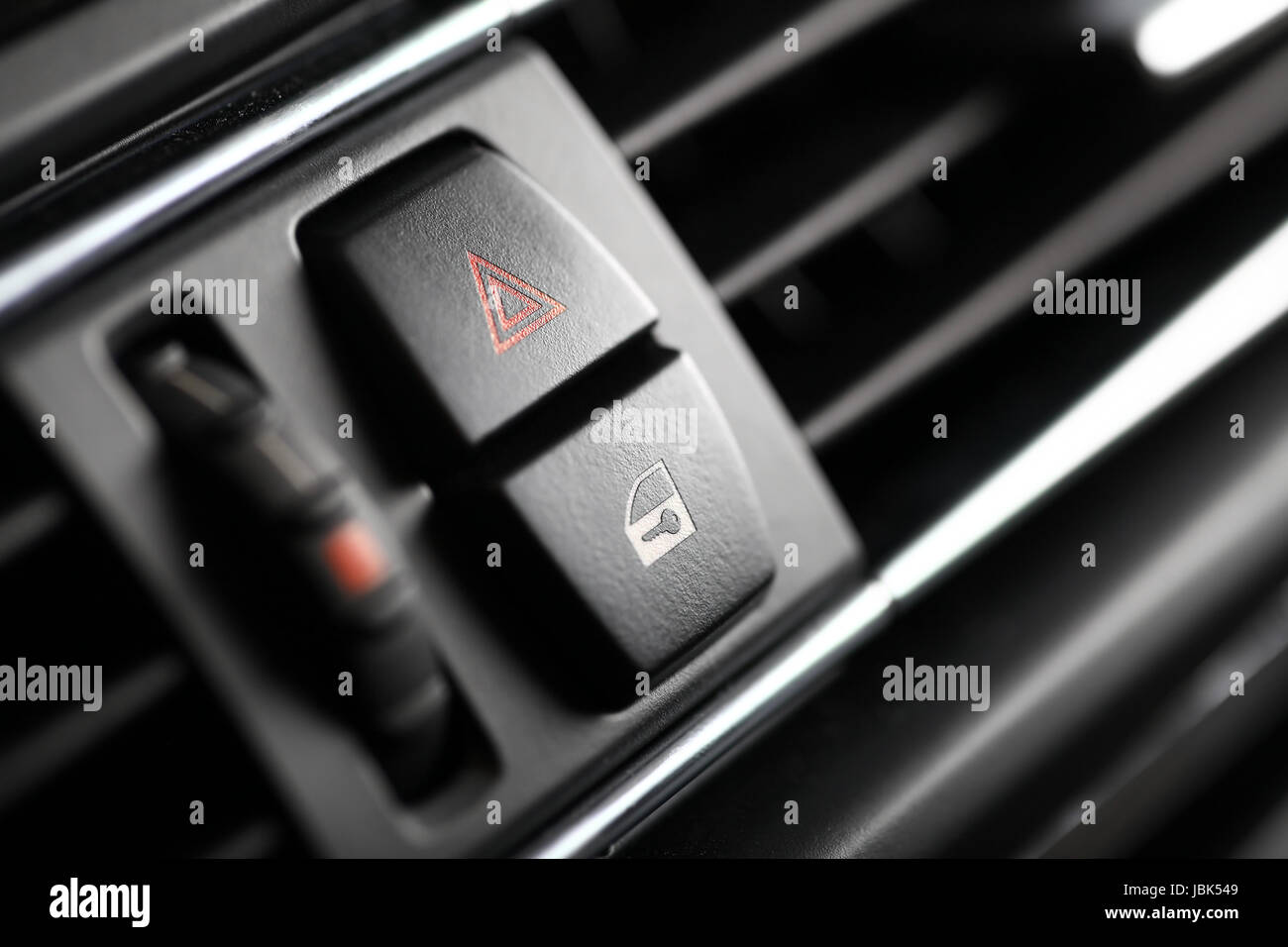 Detail of a warning button in a car Stock Photo - Alamy