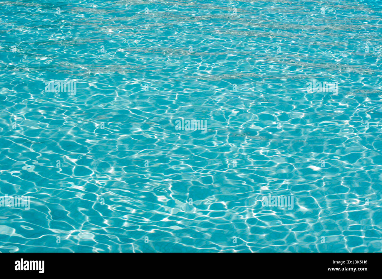 Blue pool water with sun reflections Stock Photo - Alamy
