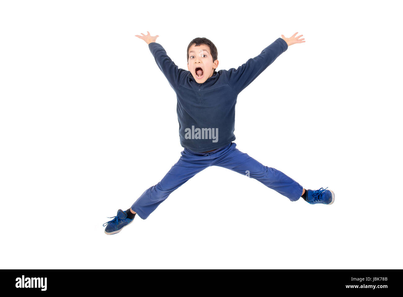 Young boy jumping isolated in white Stock Photo - Alamy