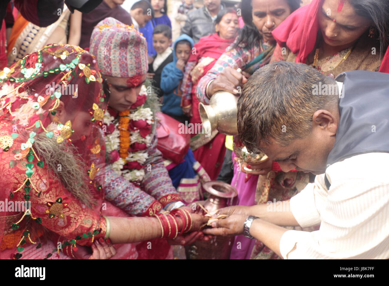 wedding ceremony family giving hand to to bright groom Stock Photo - Alamy