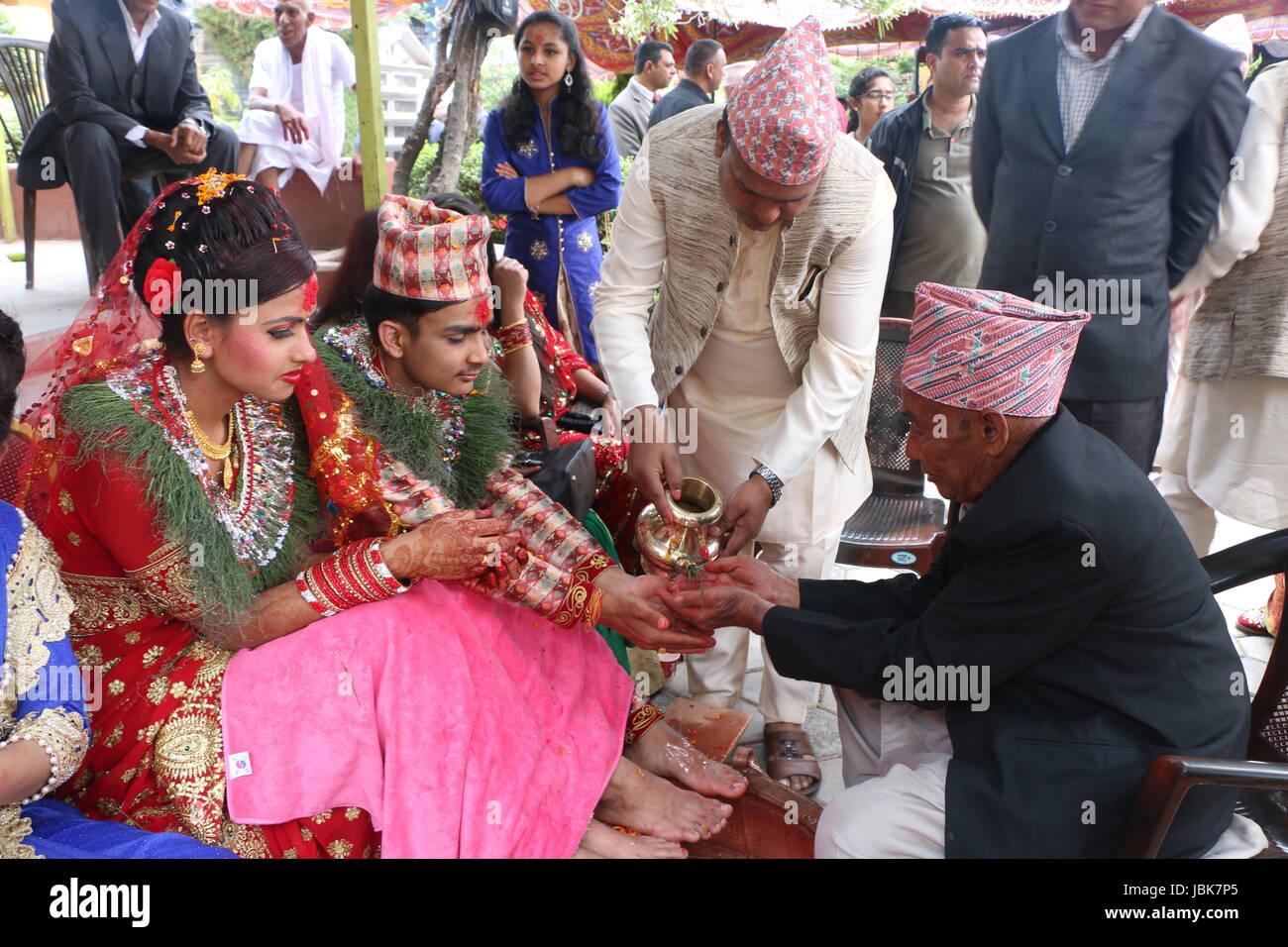 wedding ceremony family giving hand to to bright groom Stock Photo - Alamy